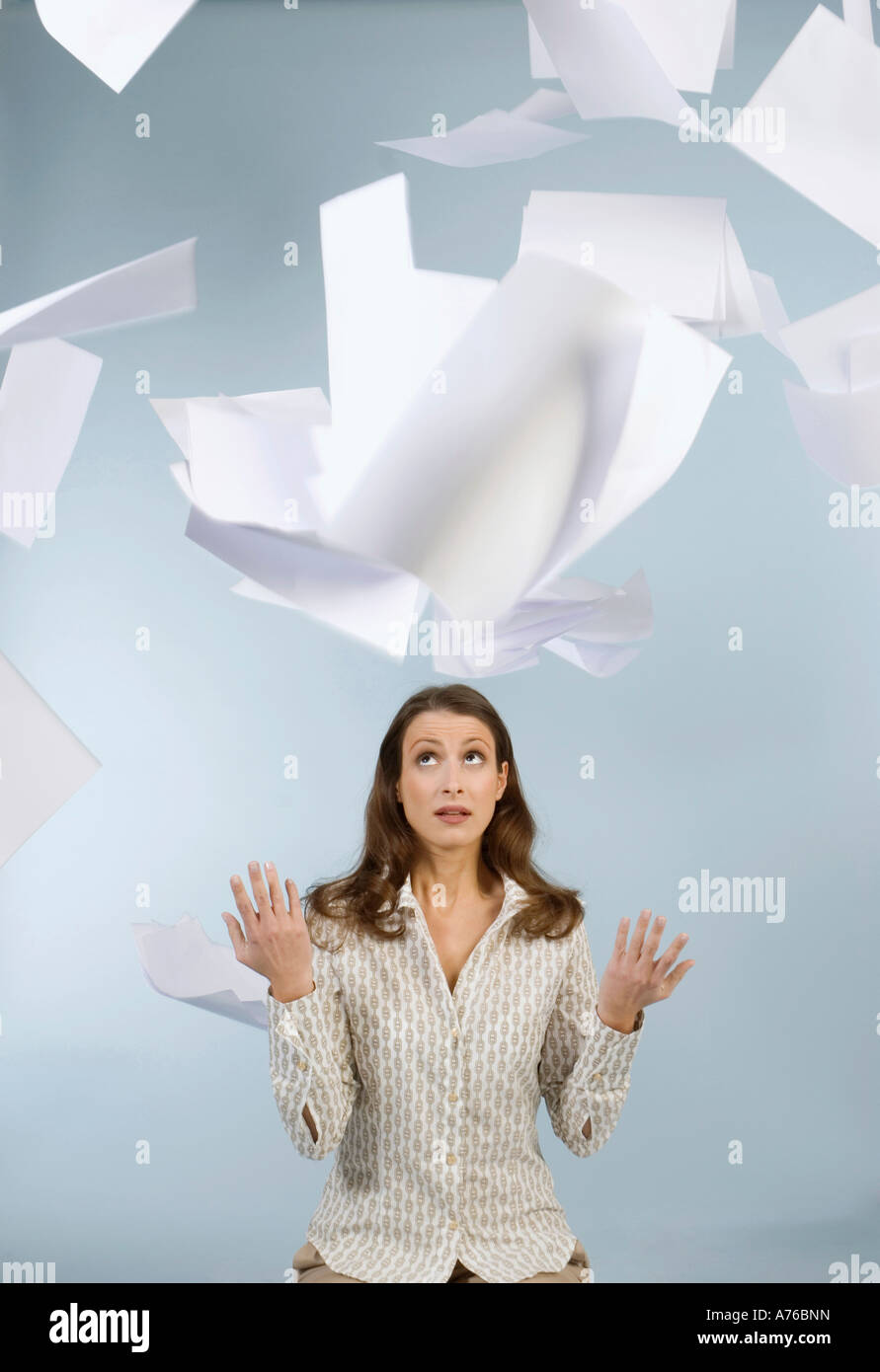 Businesswoman throwing papers in air Stock Photo - Alamy