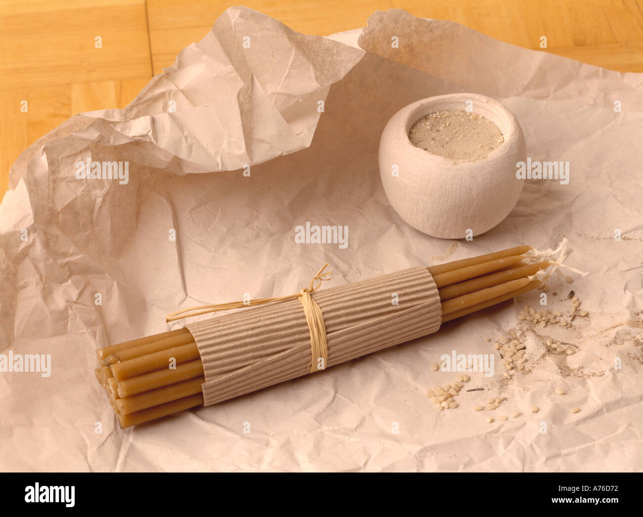 Opened parcel of stone candle holder with set of candles in light brown ...