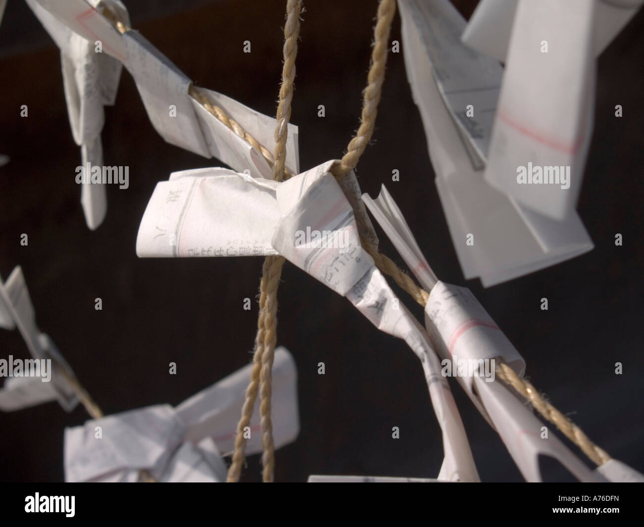 Notes with prayers tied to string Stock Photo - Alamy