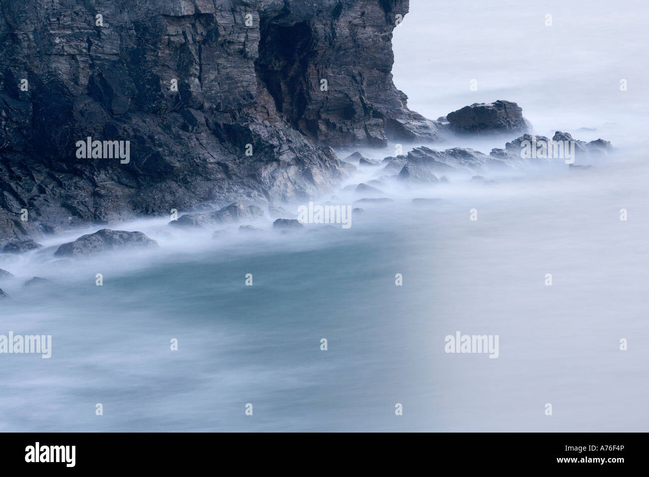 The sea meets the base of cliffs Stock Photo - Alamy
