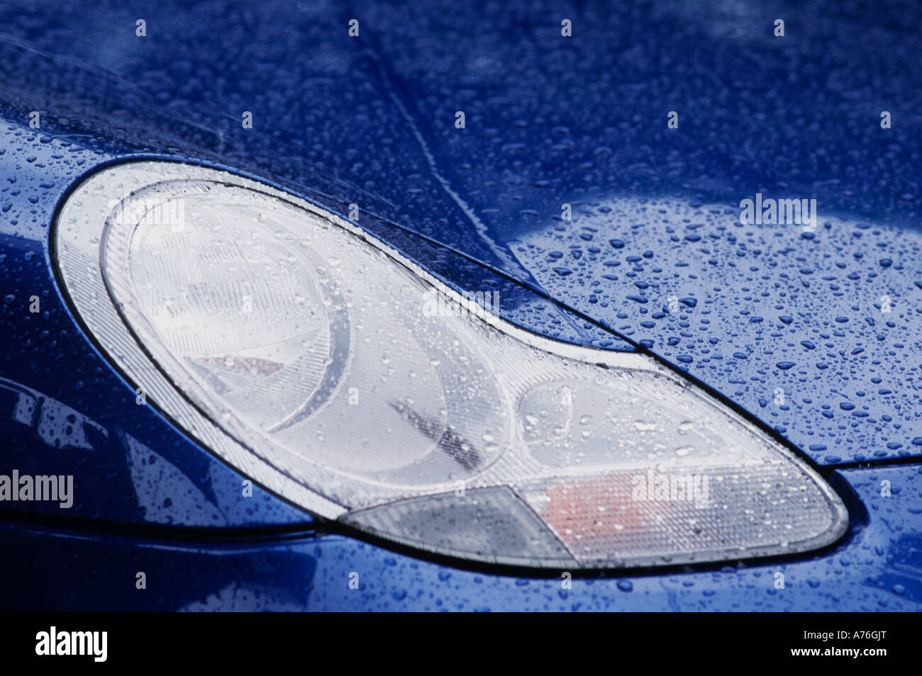 blue Porsche 911 Carrera head light covered in rain Stock Photo - Alamy