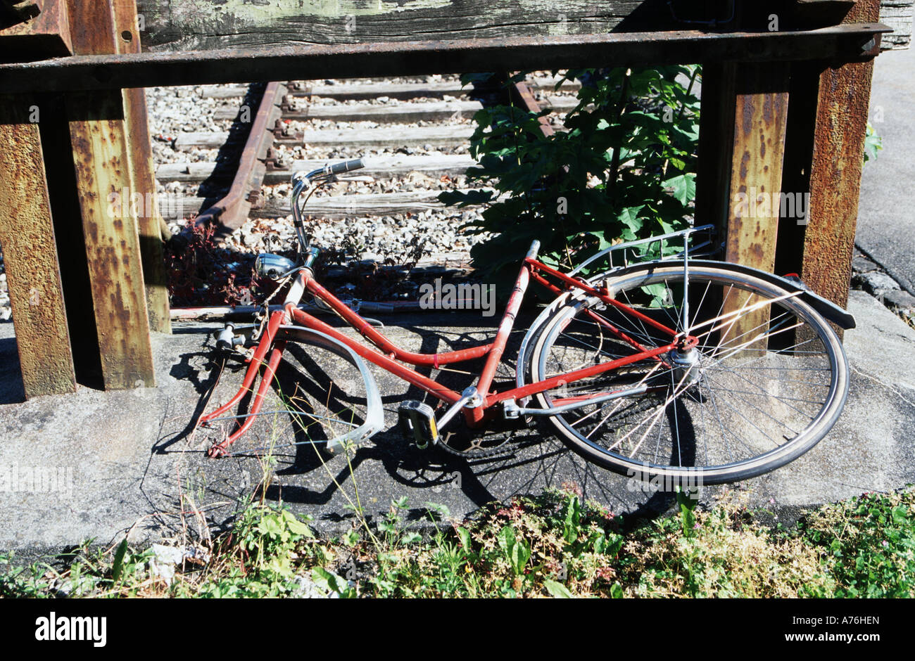 Railway buffers in Italy at the end of the line with vandalised bike or ...
