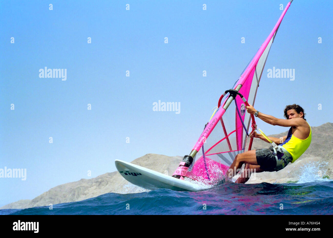 A windsurfer racing along the surface of the sea. This was shot from ...