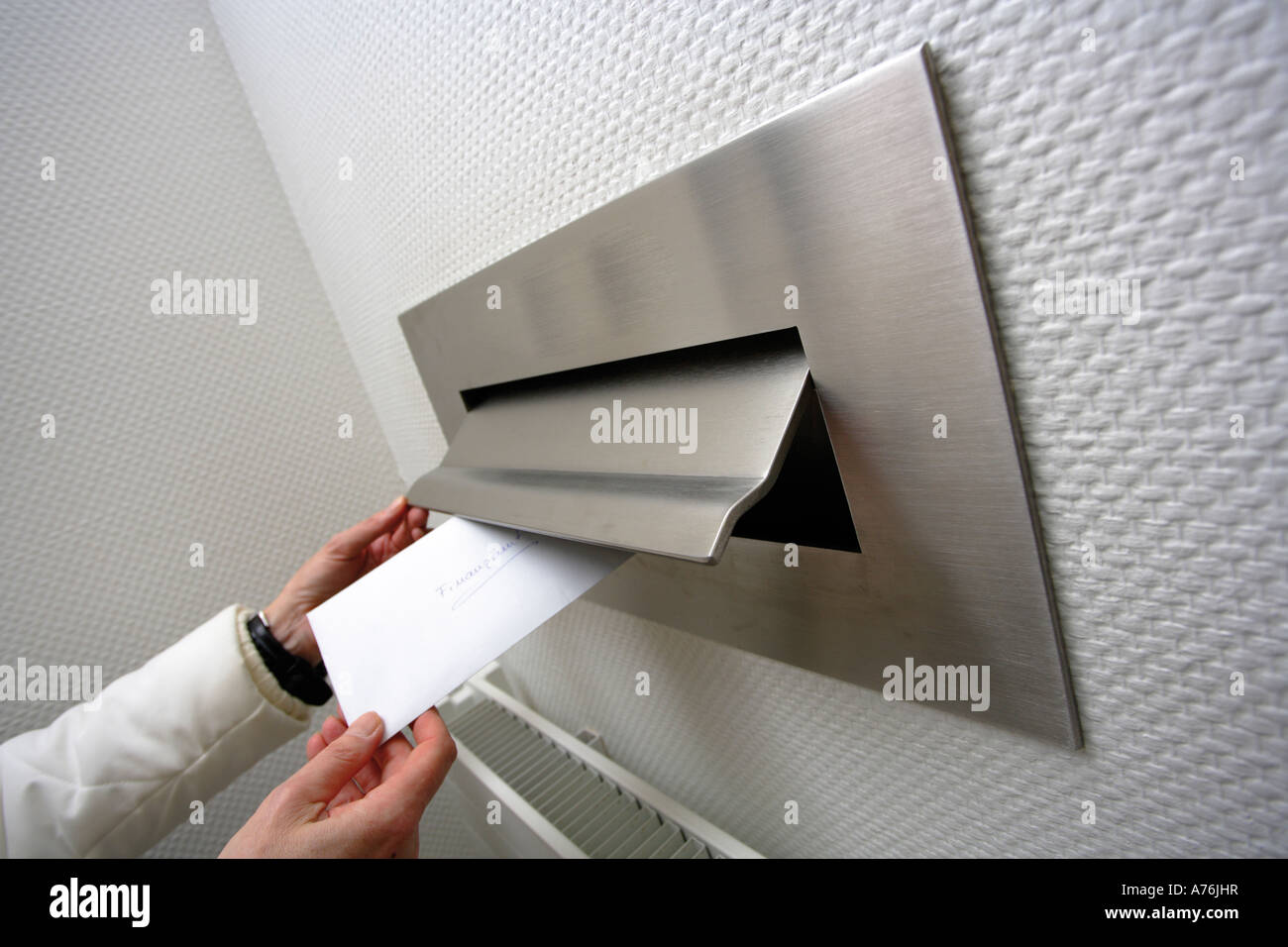 Human hand throwing letter in letterbox, close-up Stock Photo - Alamy