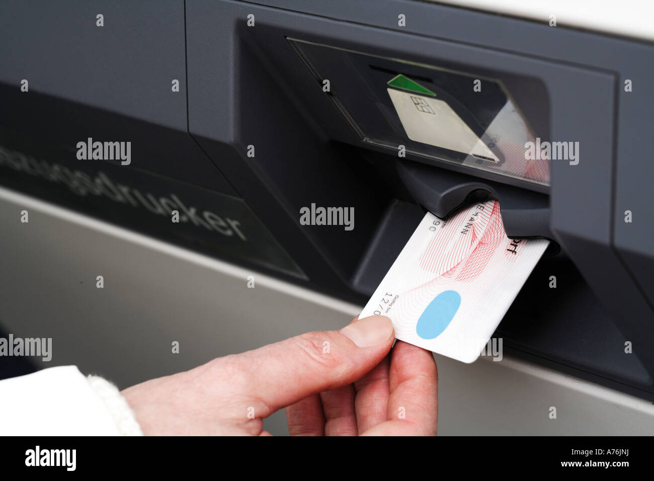 Hand pushing credit card into cash terminal, close-up Stock Photo - Alamy