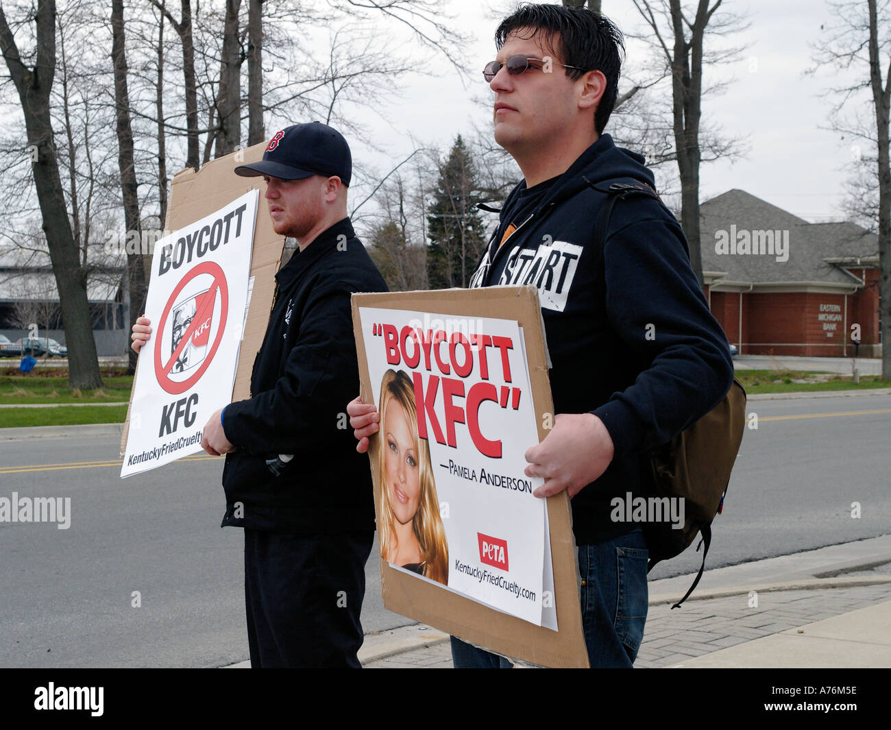 Two young men protest outside the Kentucky Fried Chicken on behalf of ...