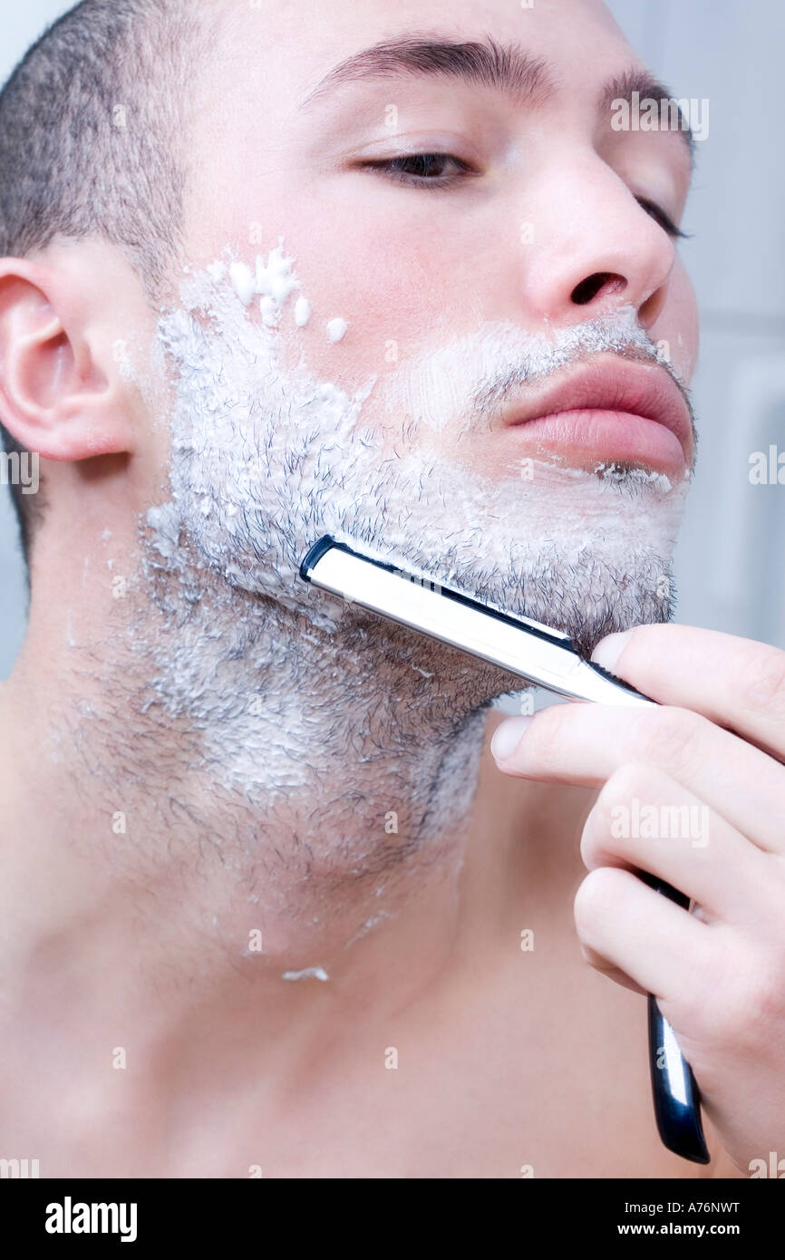 Man shaving with razor, close-up Stock Photo - Alamy
