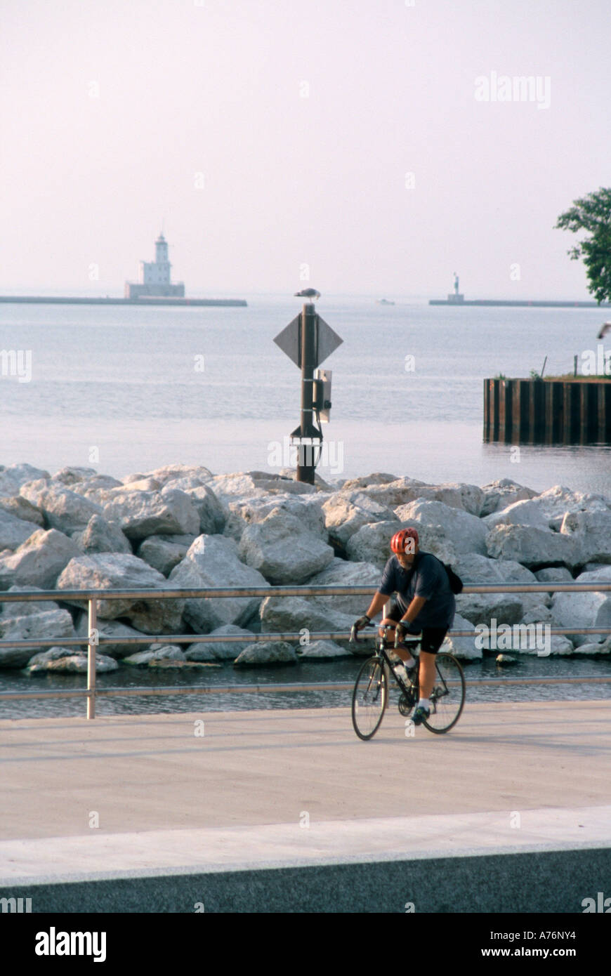 A biker riding along Lake Michigan lakefront bike path in Milwaukee ...