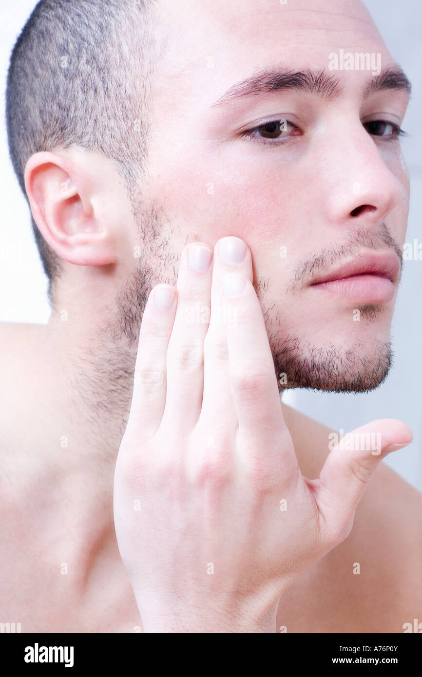 Man applying face cream, close-up Stock Photo - Alamy
