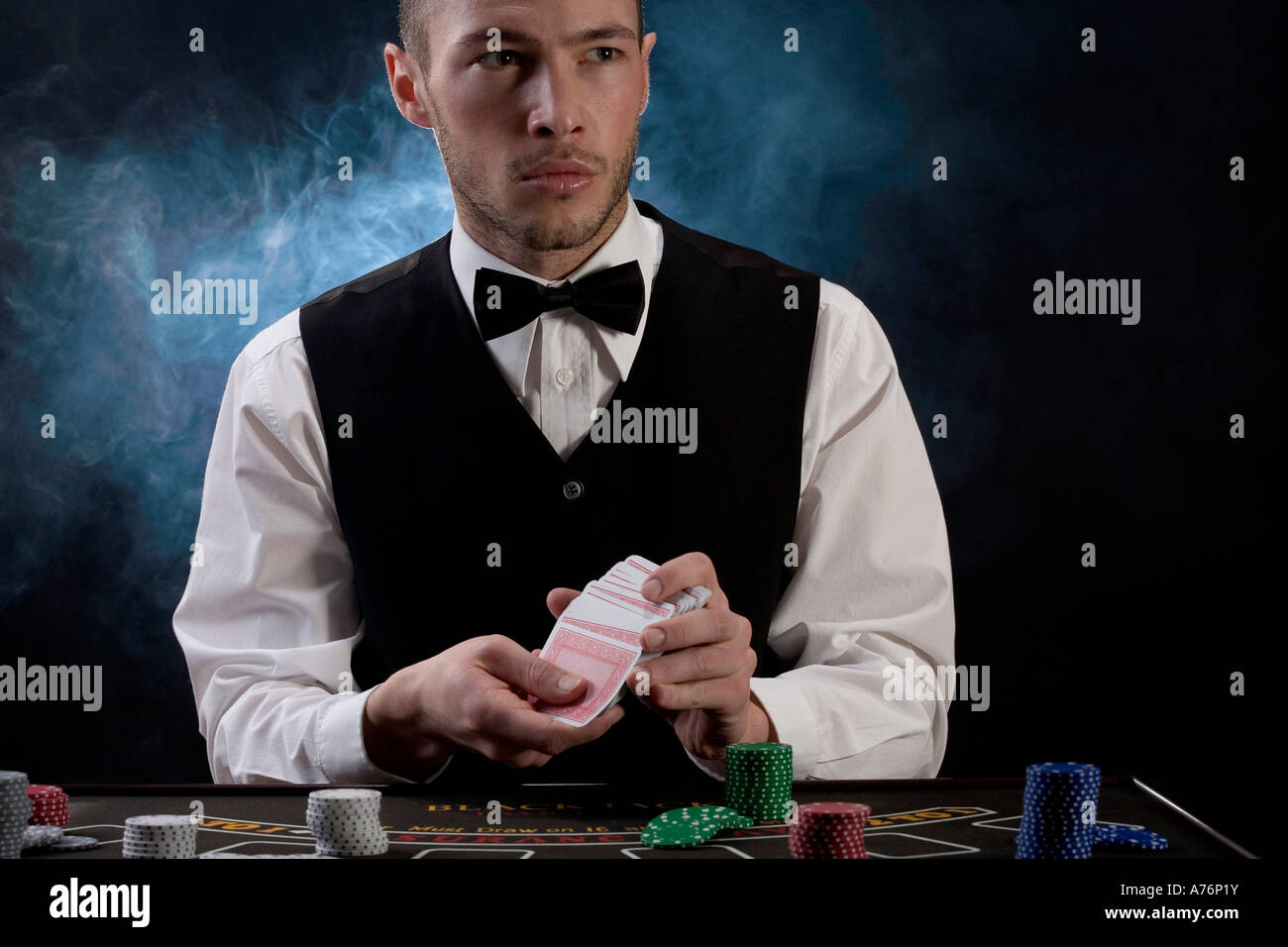 Man shuffling playing cards Stock Photo - Alamy
