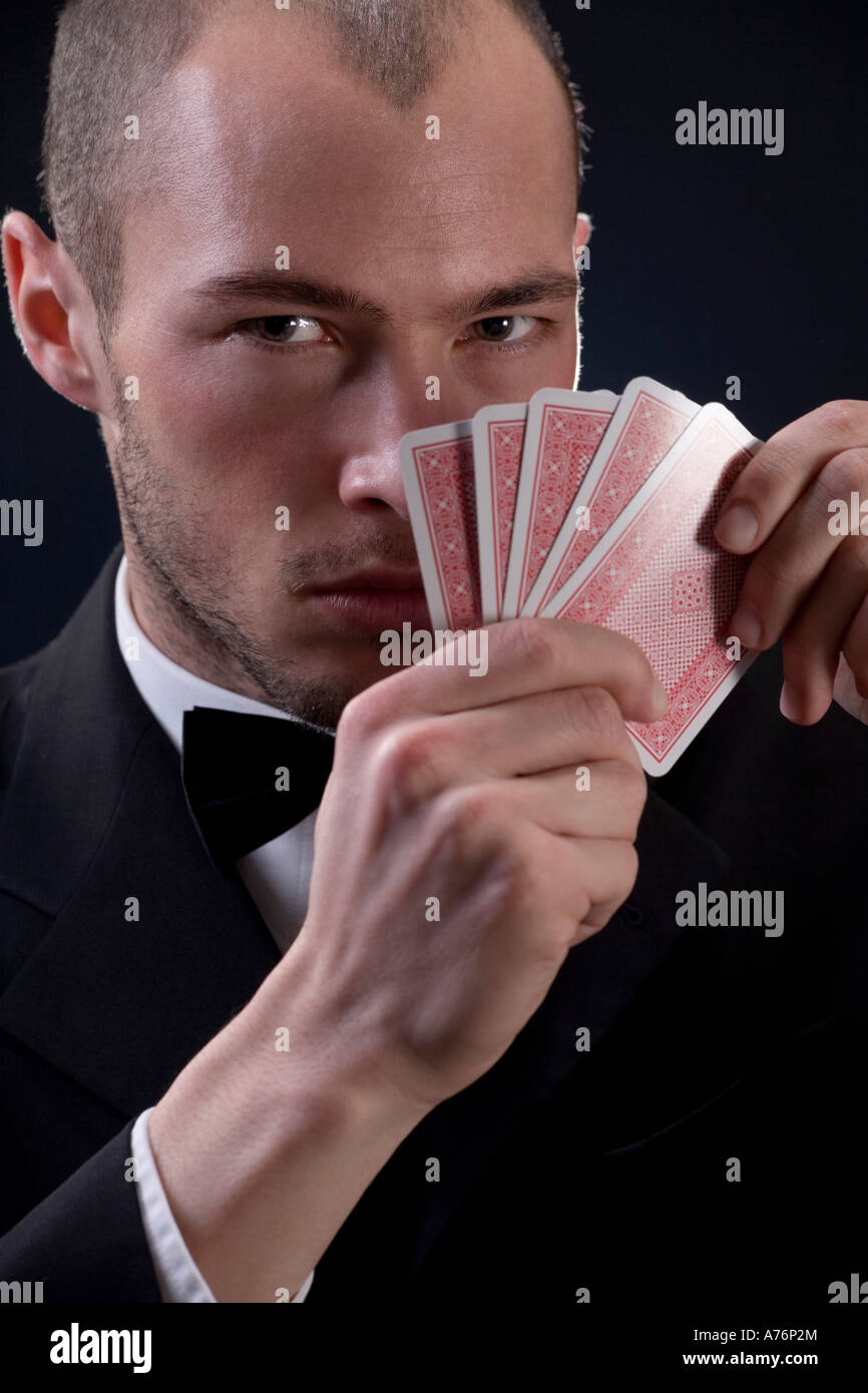 Man holding playing cards Stock Photo - Alamy