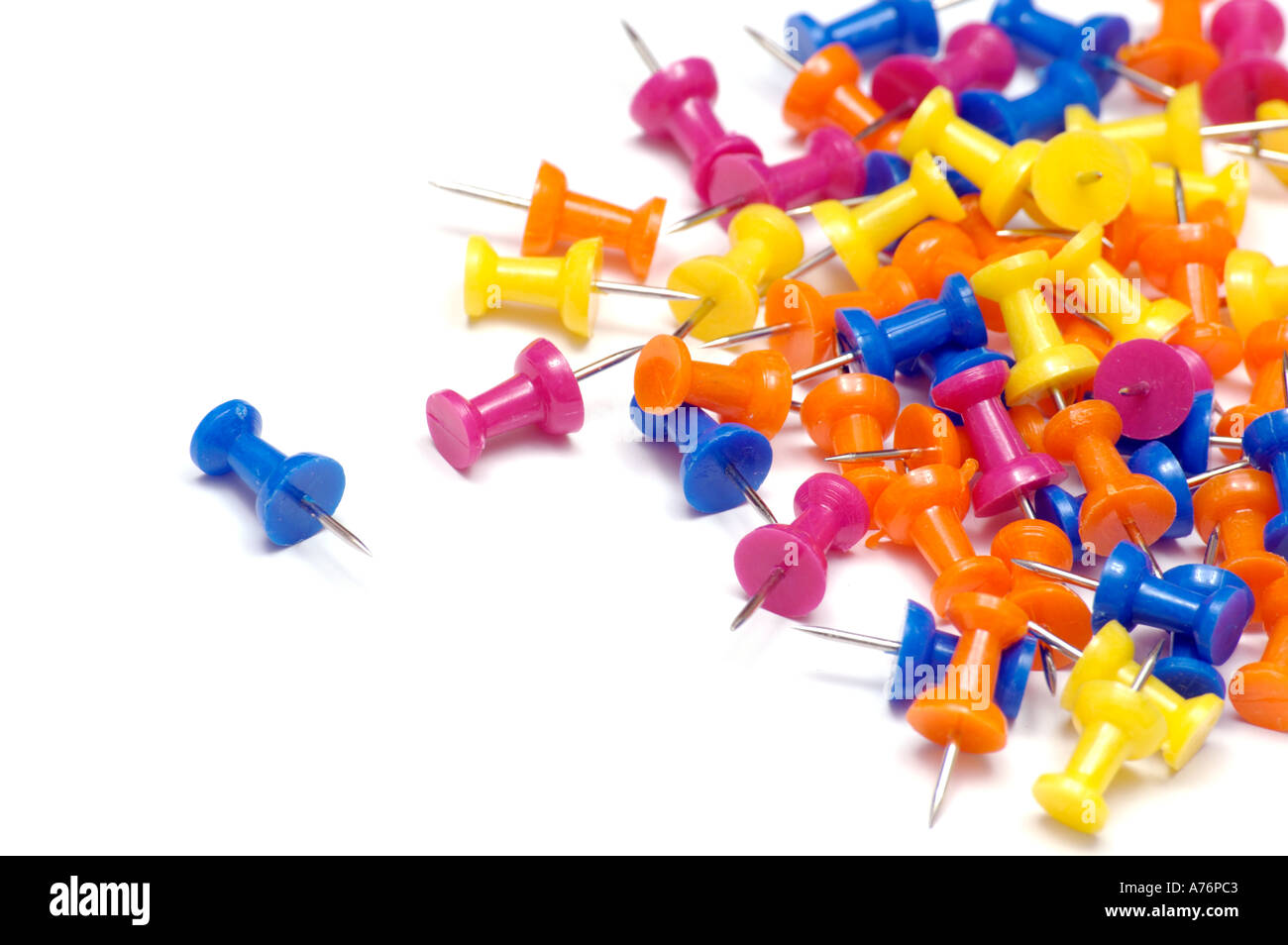 Office stationery colourful softboard pins strewn on white background ...