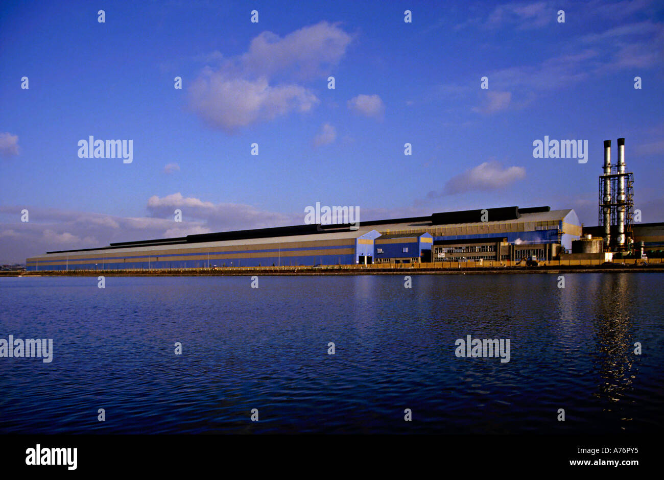 Industrial warehouses and chimneys at steelworks alongside Atlantic ...