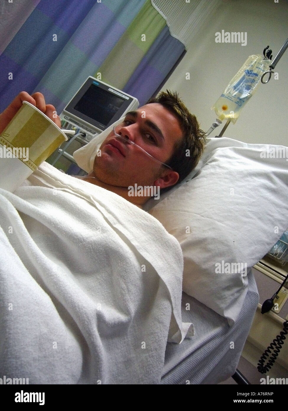 male patient in hospital bed drinking Stock Photo - Alamy