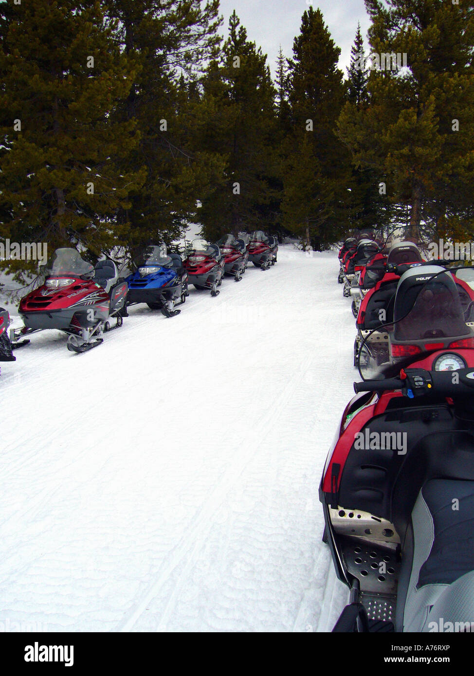 snowmobiles lined up in the snow Stock Photo - Alamy