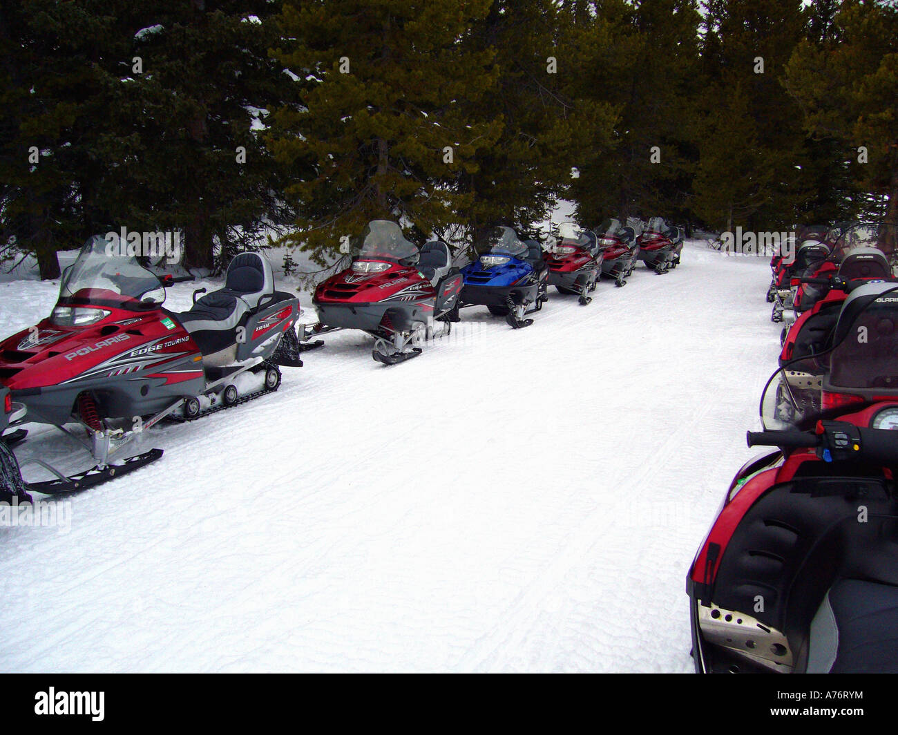 snowmobiles lined up in the snow Stock Photo - Alamy