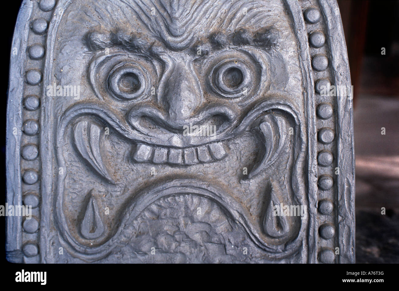 Sculpted roof tile at eaves Face with fierce features Japan Stock Photo ...