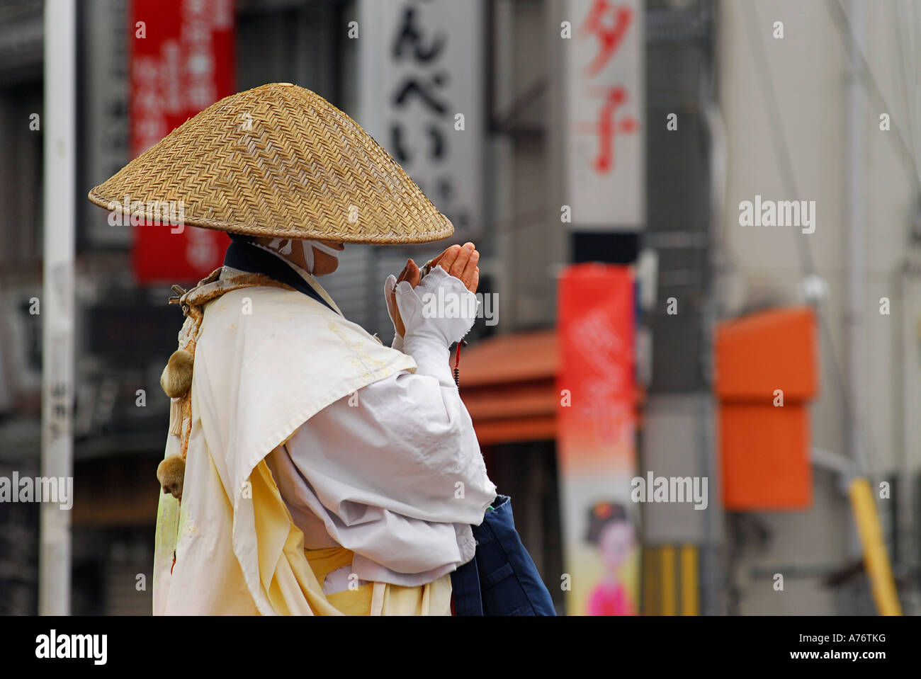 Japanese wandering monk offering prayer on a bridge in Inari Kyoto ...