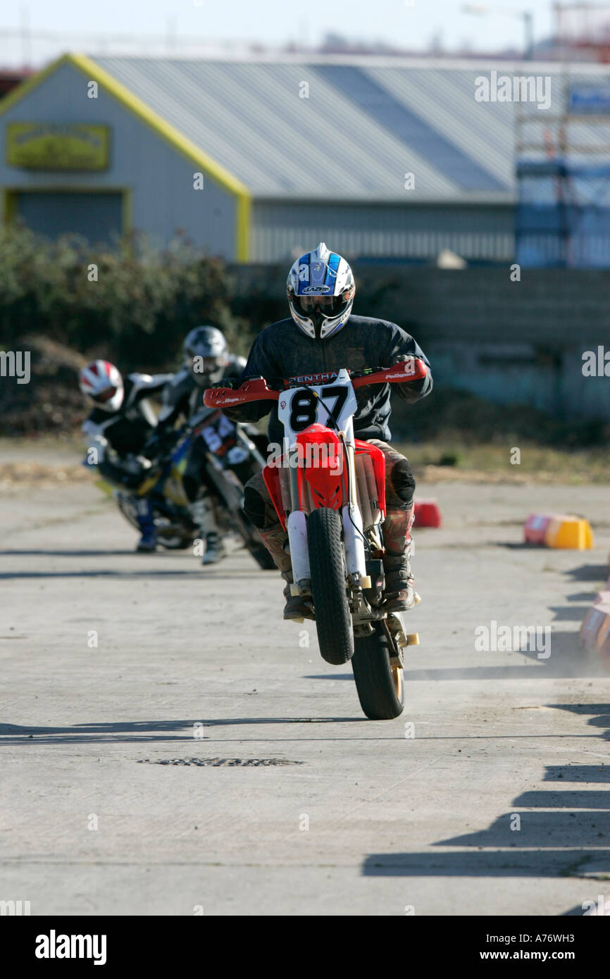 motocross rider wheelies his bike during race at the Motorcycle and ...