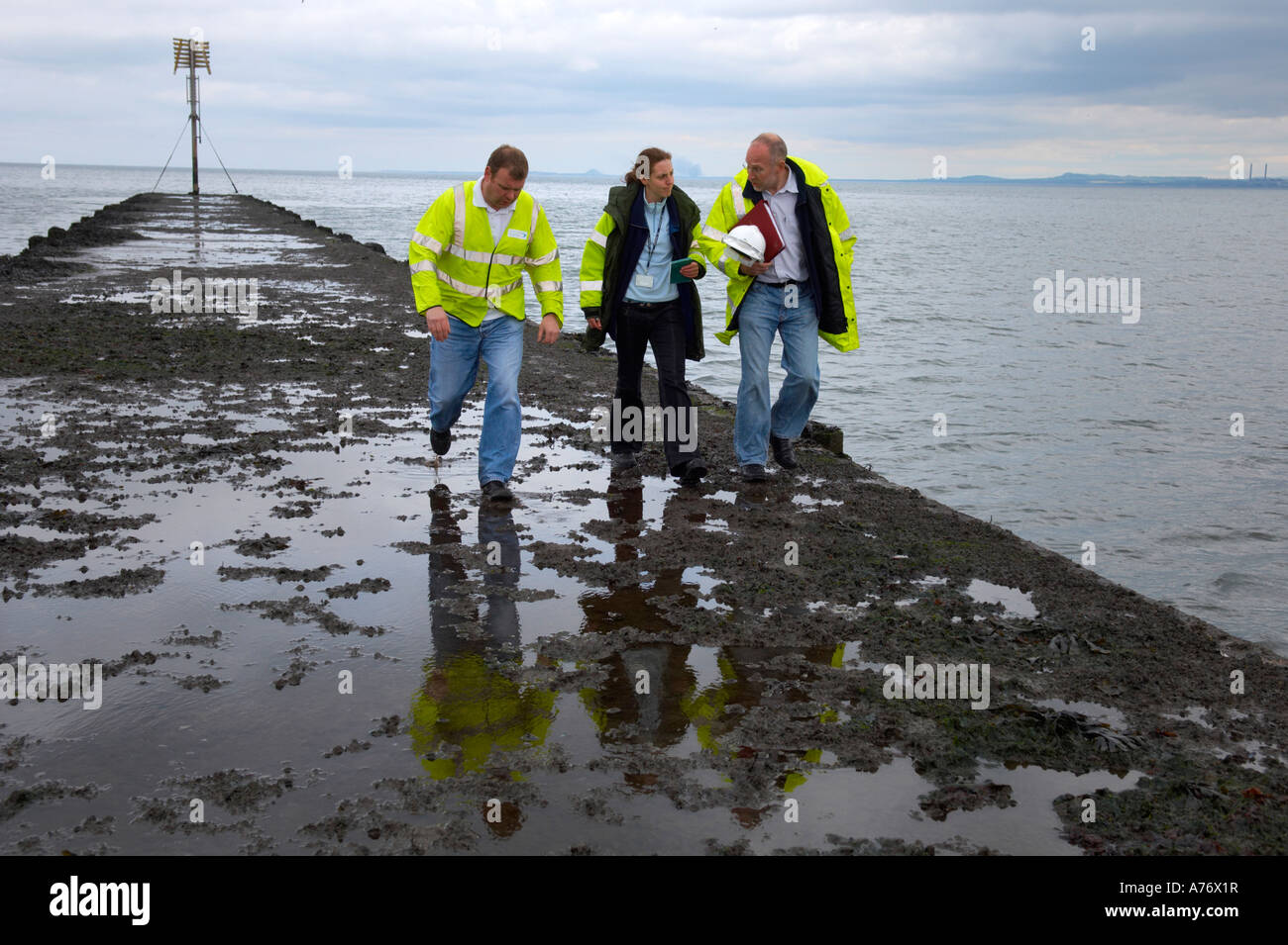Inspectors walking on the jetty near the Seafield Wastewater Treatment ...