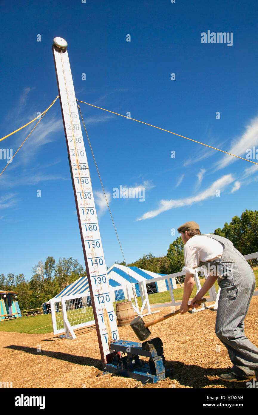 Man hitting the high striker Stock Photo - Alamy