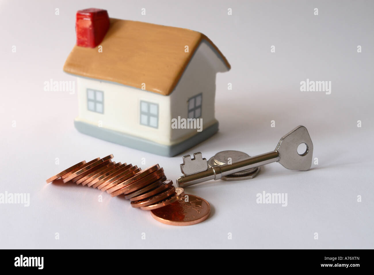 Cost of housing home concept money coin key Stock Photo - Alamy