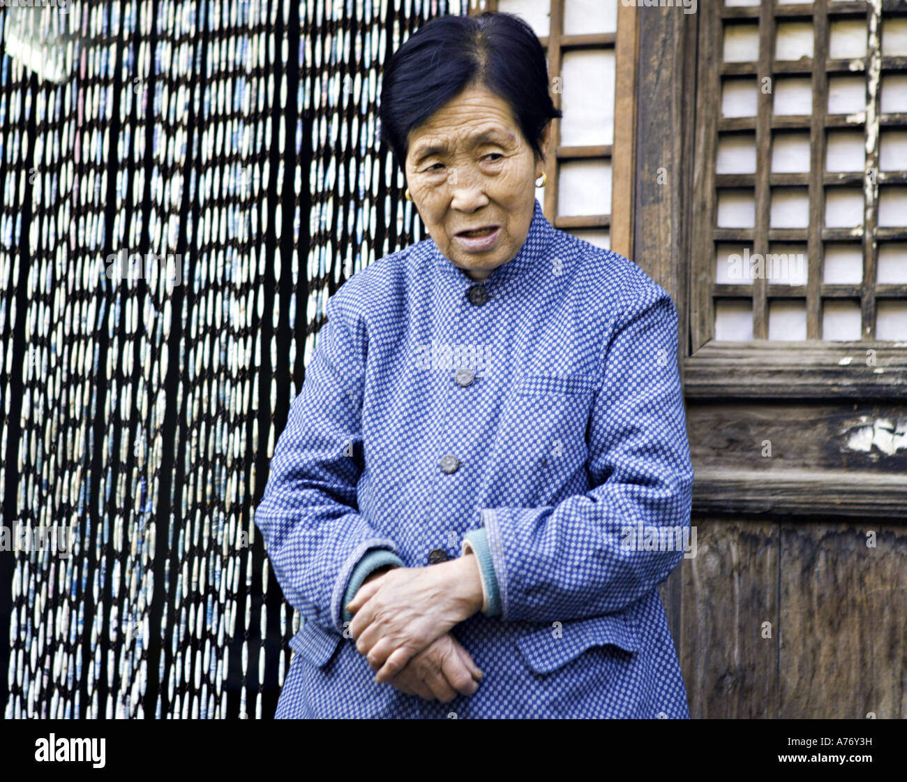 CHINA ChuanDiXia Elderly female owner of a guest house wearing ...