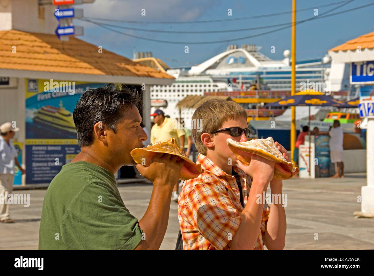 Cozumel Mexico San Miguel town learning to blow conch shell horn Stock ...