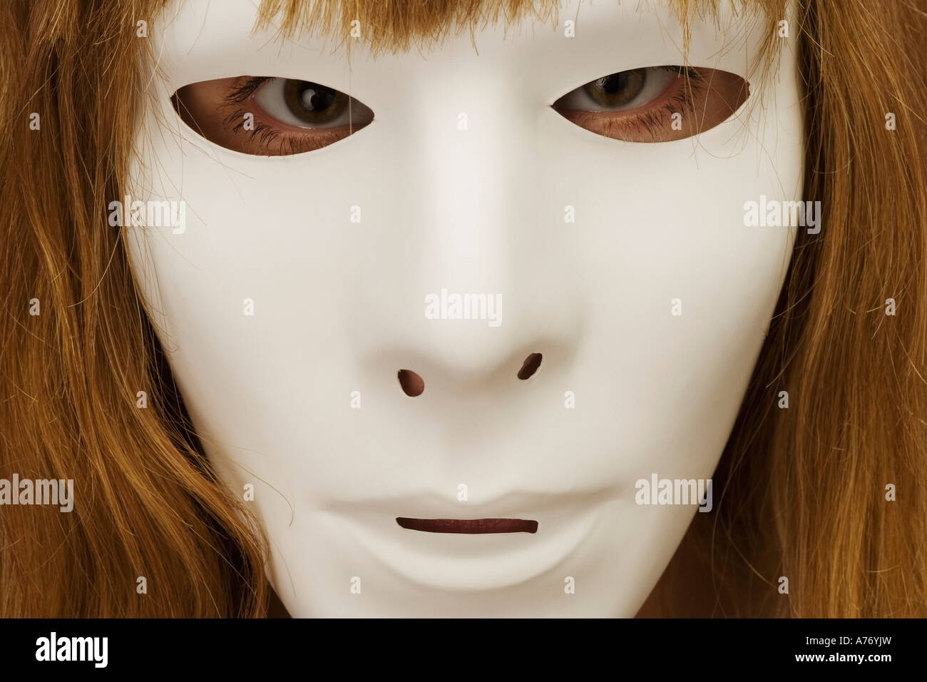 Woman hiding behind mask Stock Photo - Alamy