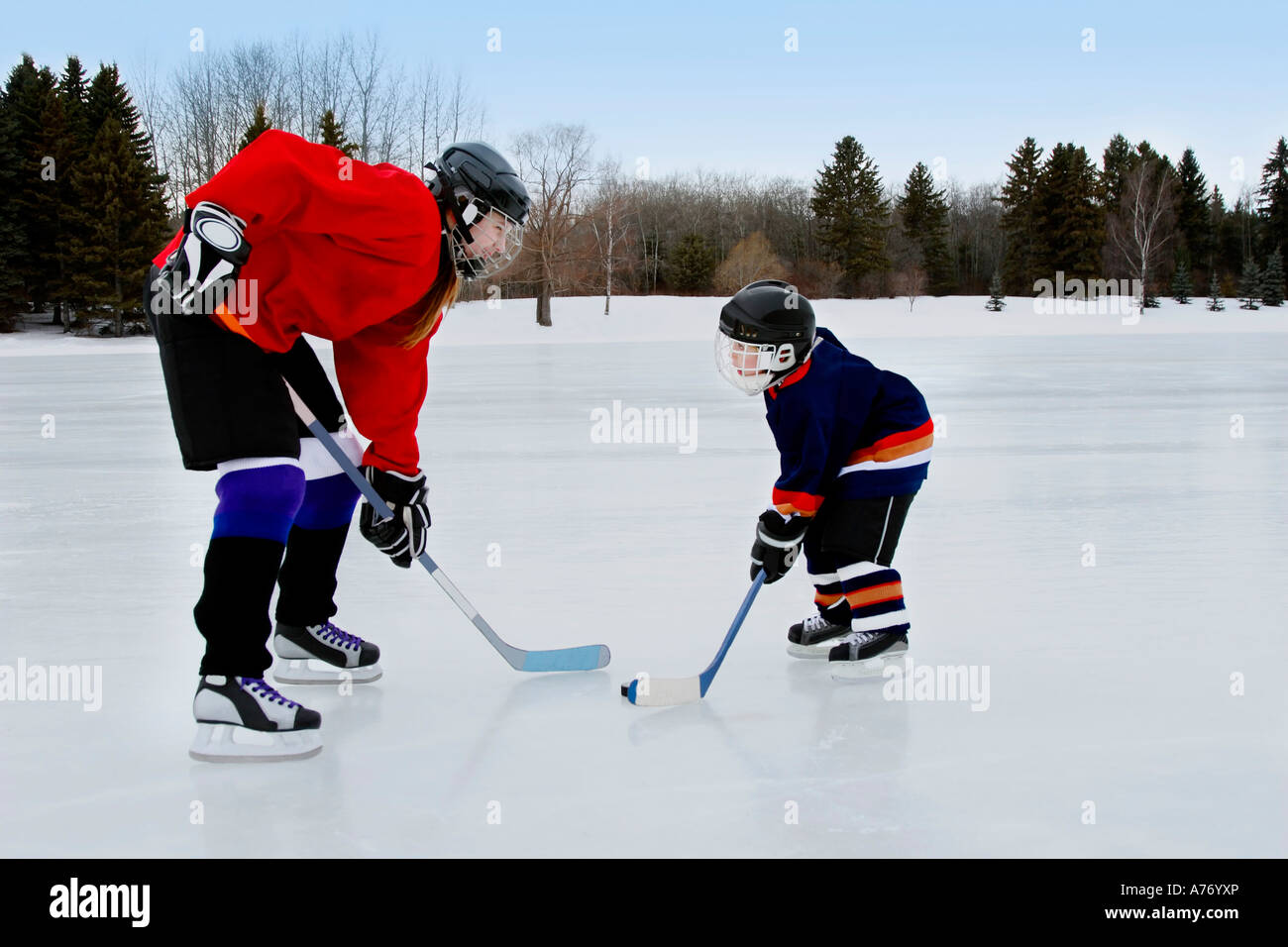 Children playing ice hockey puck hi-res stock photography and images ...