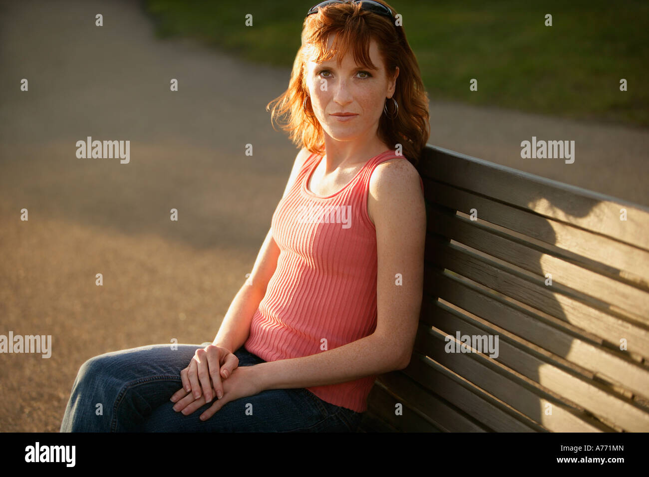 Woman sitting on a bench Stock Photo - Alamy