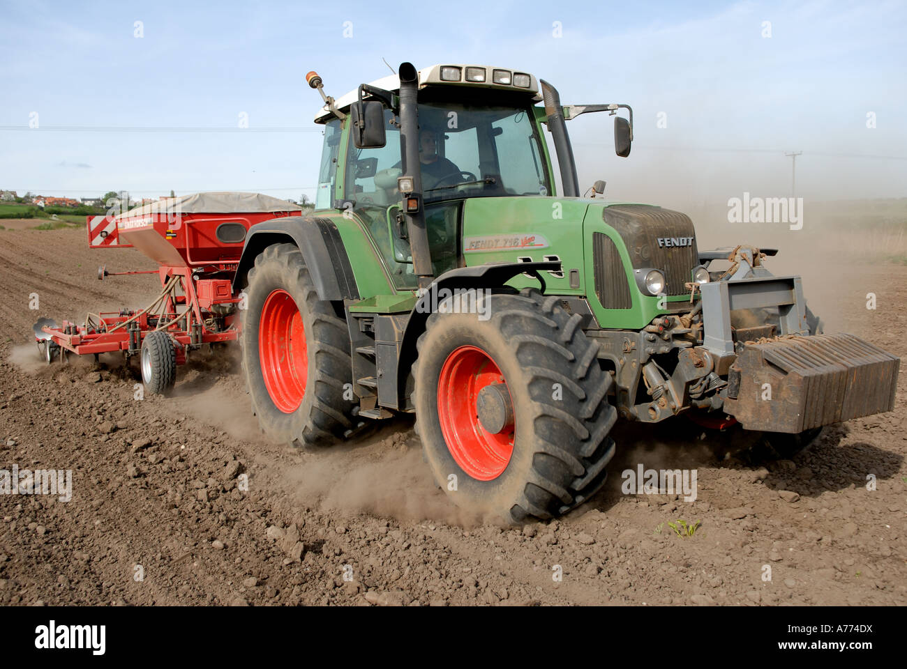 Tractor sowing barley Stock Photo - Alamy