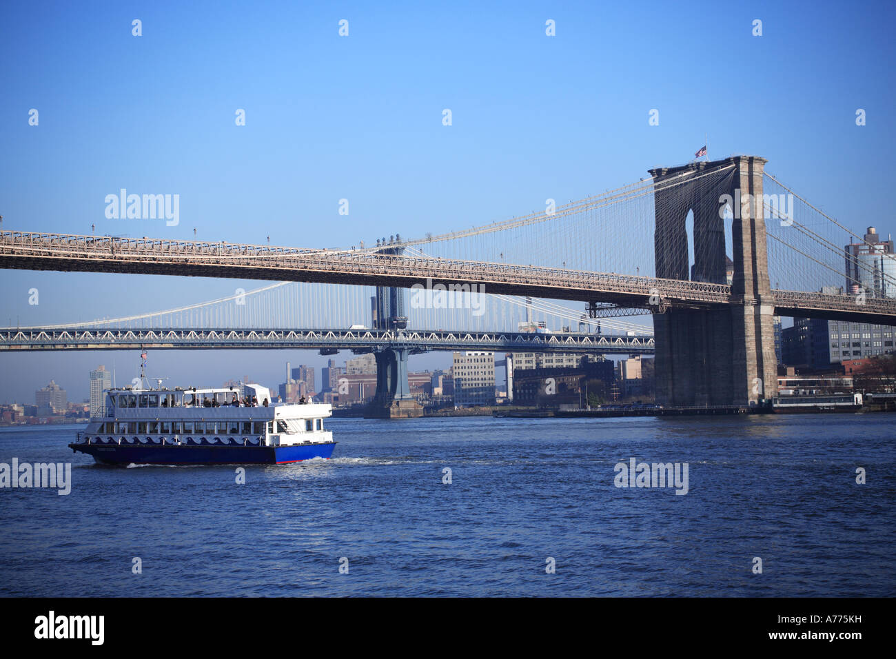 ferry on hudson river passing brooklyn bridge. manhattan, new york city ...