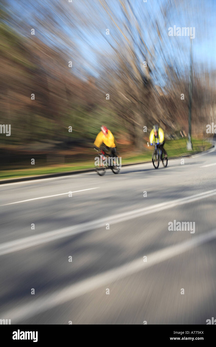 fast driving bikers on street in central park, manhattan, new york city ...