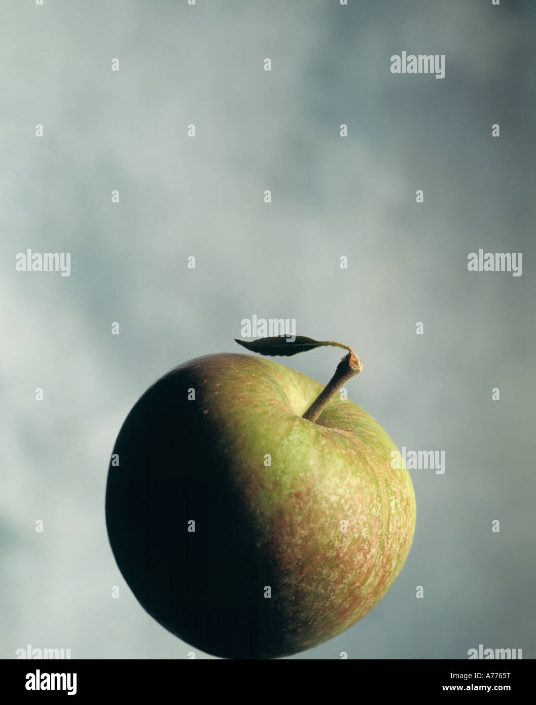 Apple with leaf on soft cloudy textured background Stock Photo - Alamy