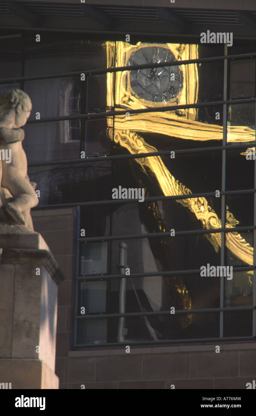 reflection of the clock on Leeds civic hall in a glass window at ...