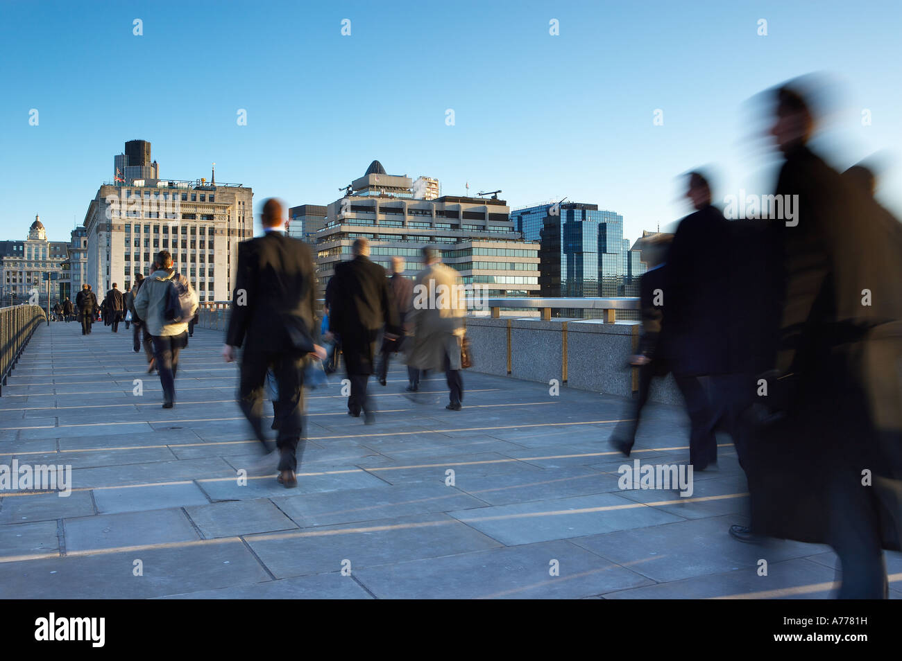 the trudge to work commuters crossing London Bridge on the way to work ...