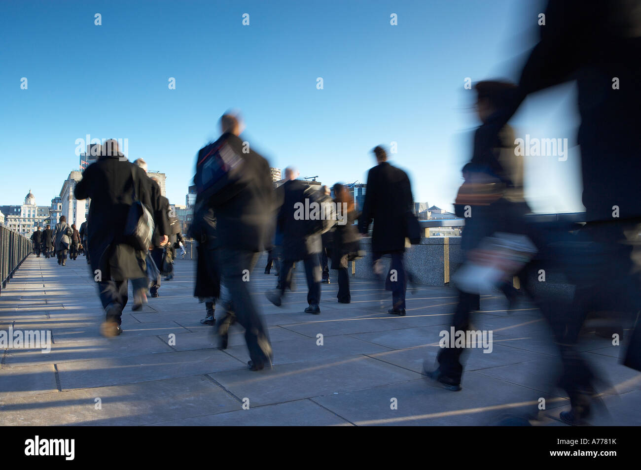 the trudge to work commuters crossing London Bridge on the way to work ...
