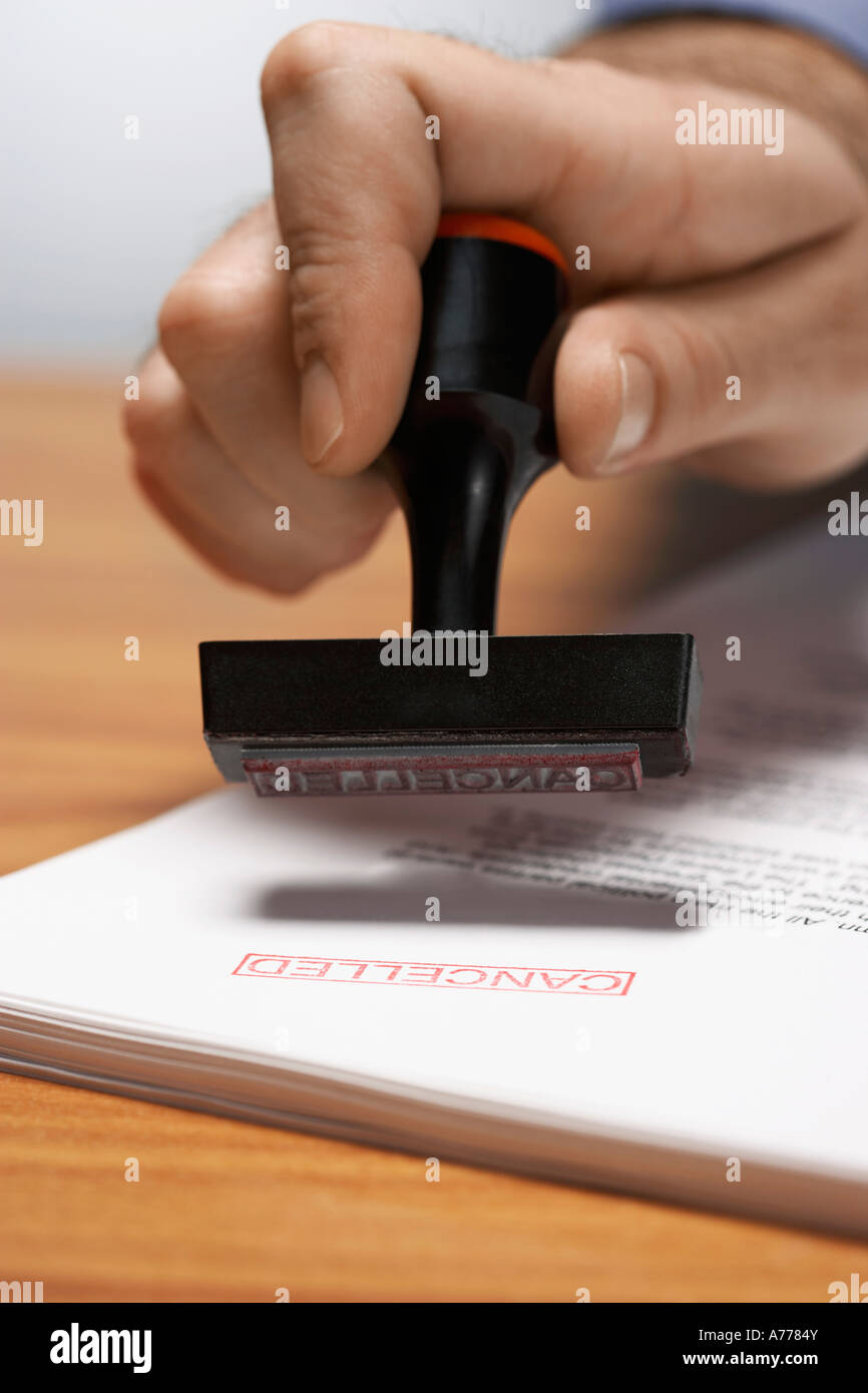 Man Using "Cancelled" Stamp Stock Photo - Alamy