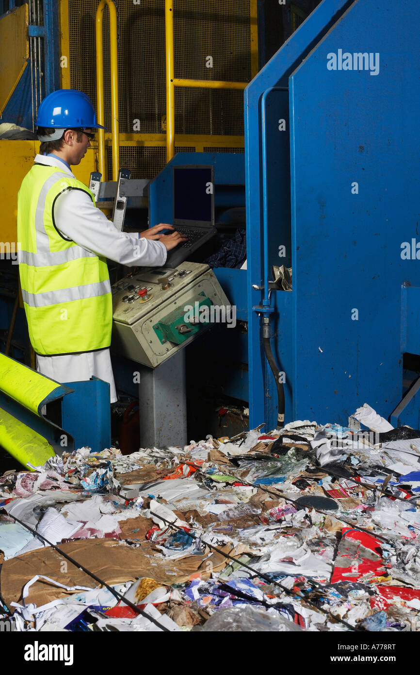 Man operating conveyor belt in recycling factory, side view Stock Photo ...
