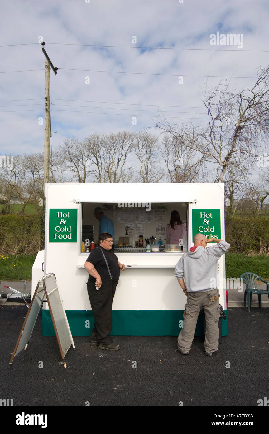 two men at roadside snack bar cafe serving fried greasy fast food in ...