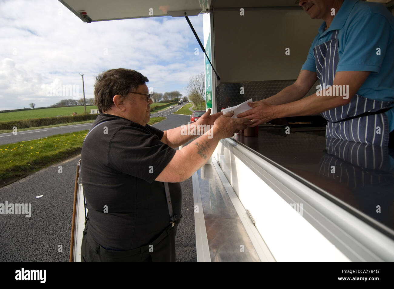man at roadside snack bar cafe serving fried greasy fast food near ...