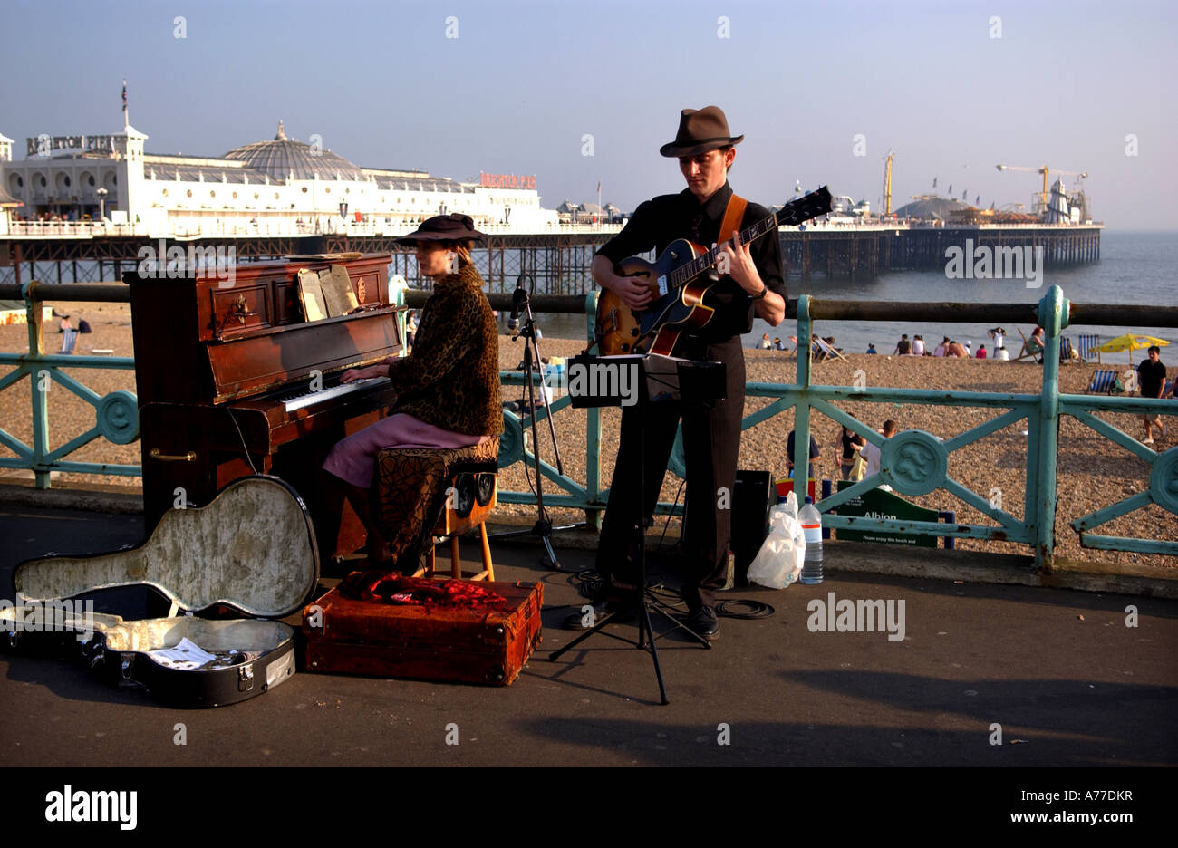 Buskers playing the guitar and a piano entertain the crowds on Brighton ...