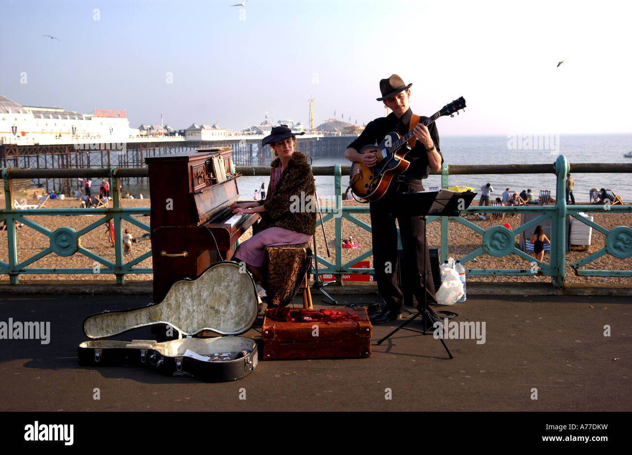 Buskers playing the guitar and a piano entertain the crowds on Brighton ...