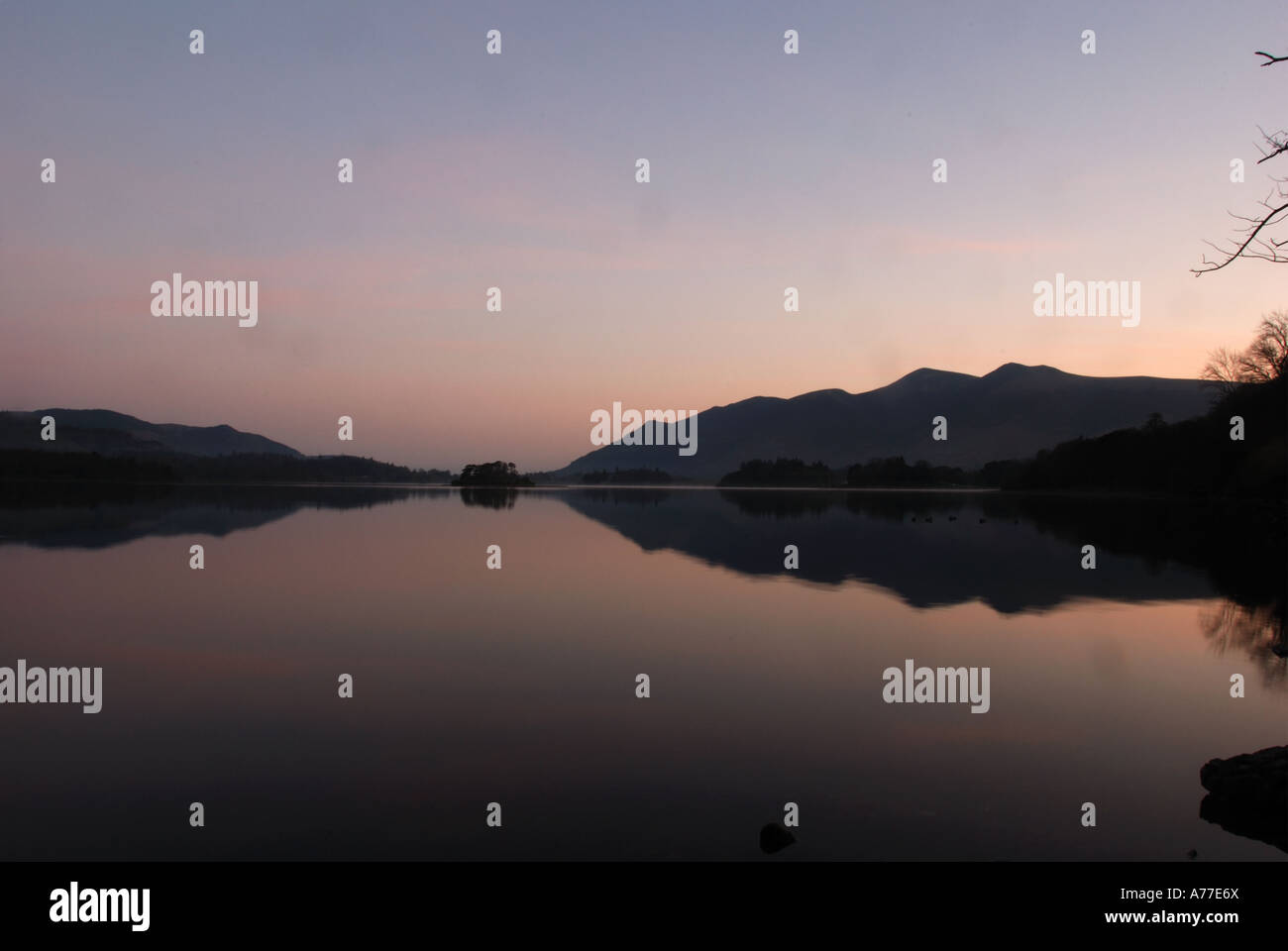 still water at sunrise Derwent Water lake district England Stock Photo ...