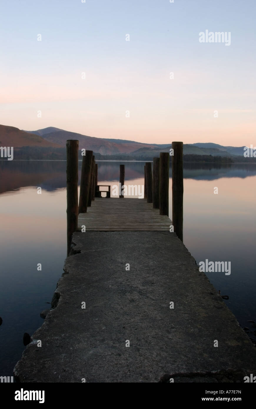 still water and Jetty at sunrise Derwent Water lake district England ...