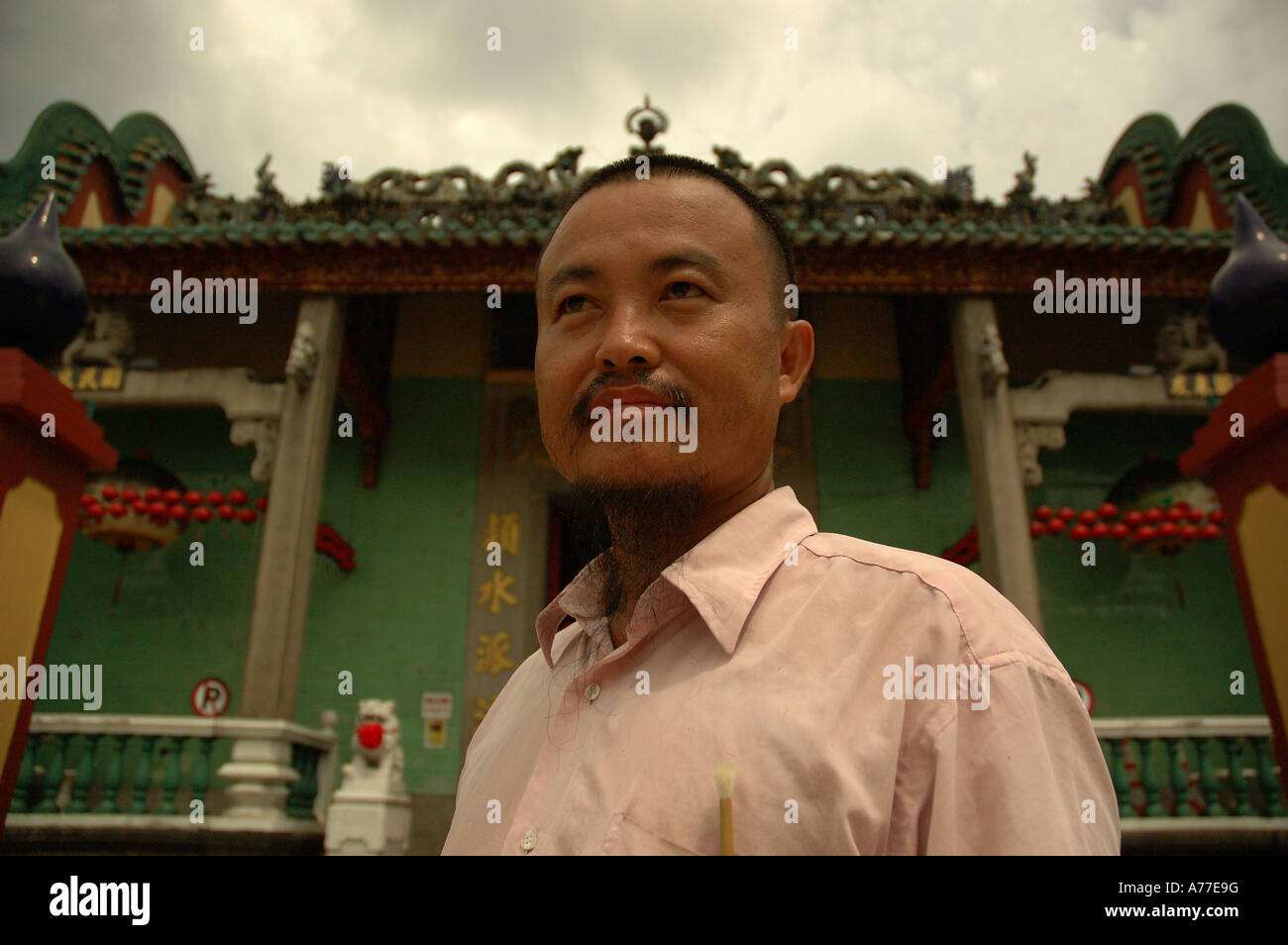 Malaysian Ethnic Chinese s tands in front of a Buddhist temple in Kuala ...