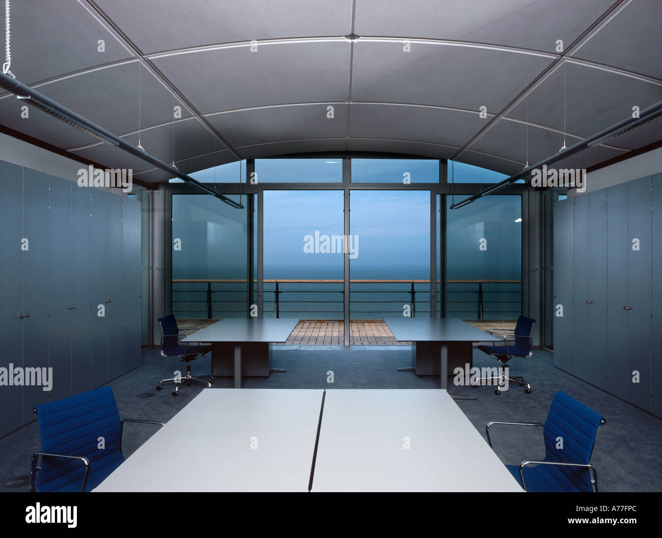View of sea through office window Stock Photo - Alamy