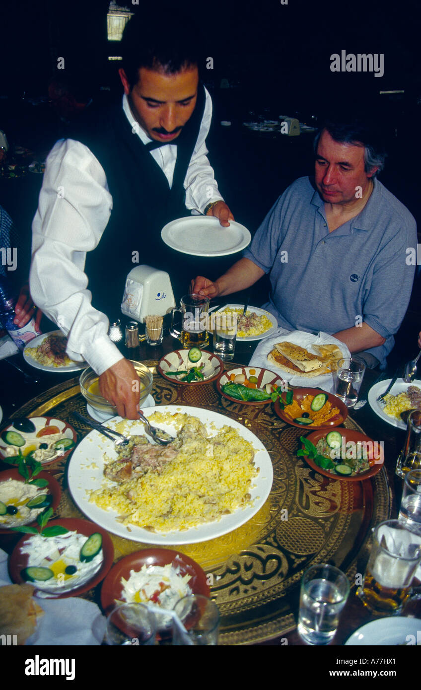 Interior Restaurant Waiter serving traditional dishes Lamb rice ...