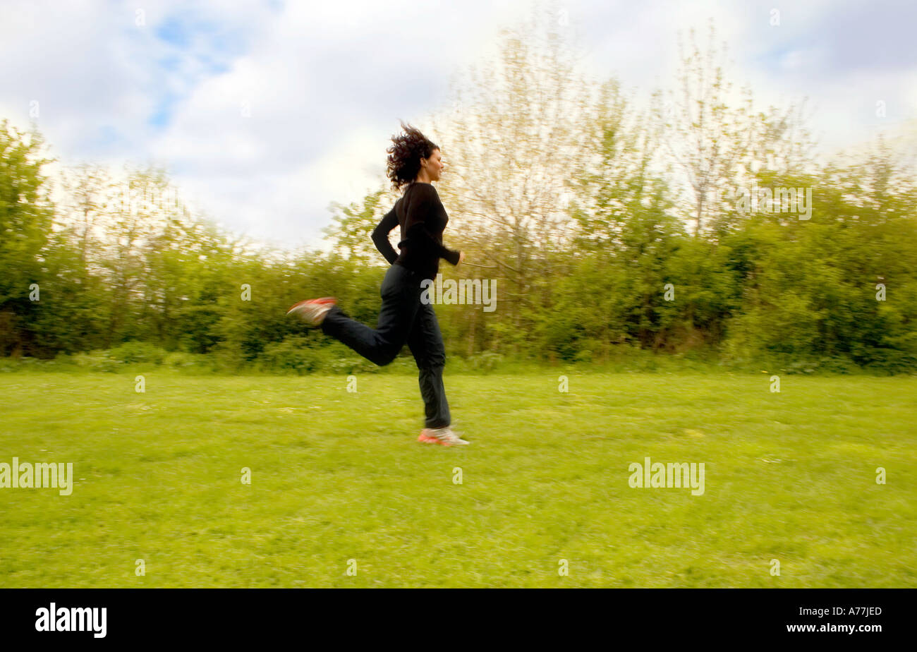 A young sporty woman running in a park Stock Photo - Alamy